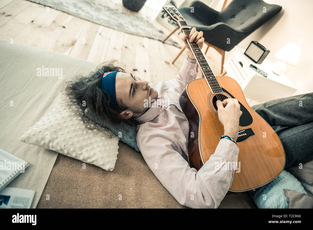 Alone long-haired man with black stubble wearing light shirt Stock ...