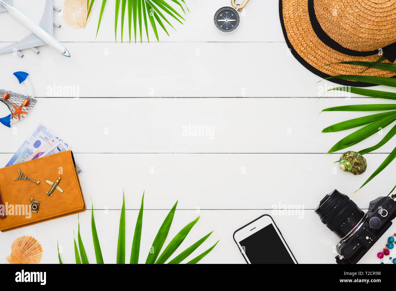 Flat lay traveler accessories on white wooden background with ...