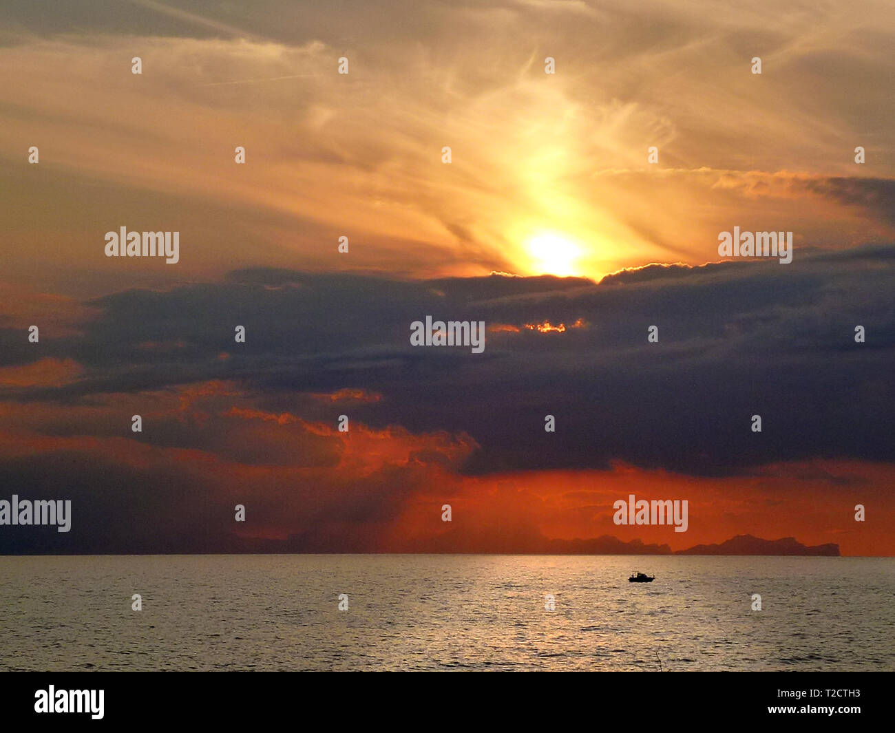Spectacular sunset with red sky and clouds over the sea of Menorca in ...