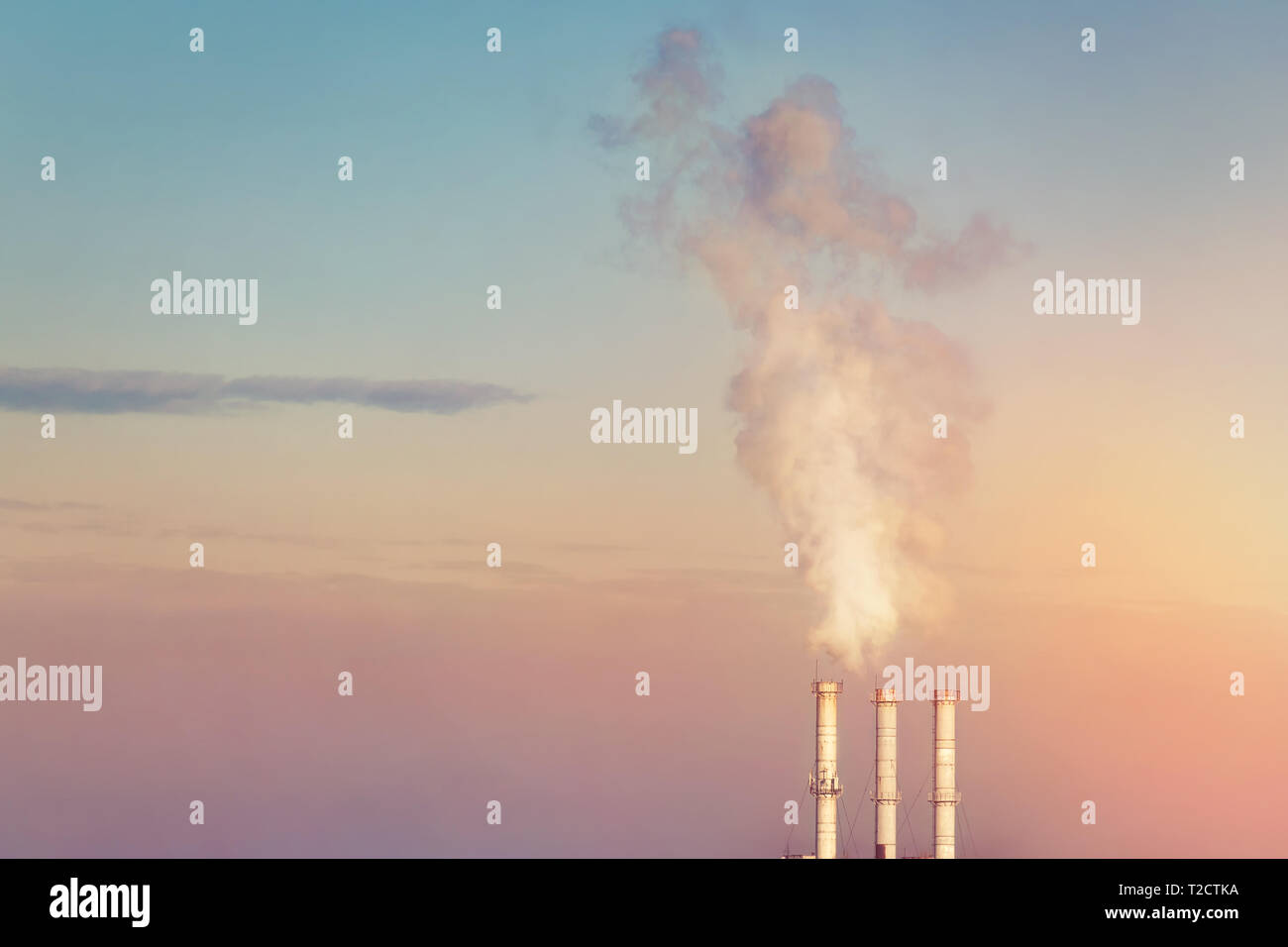 Three smoking stack pipes making clouds of white smoke with dramatic ...