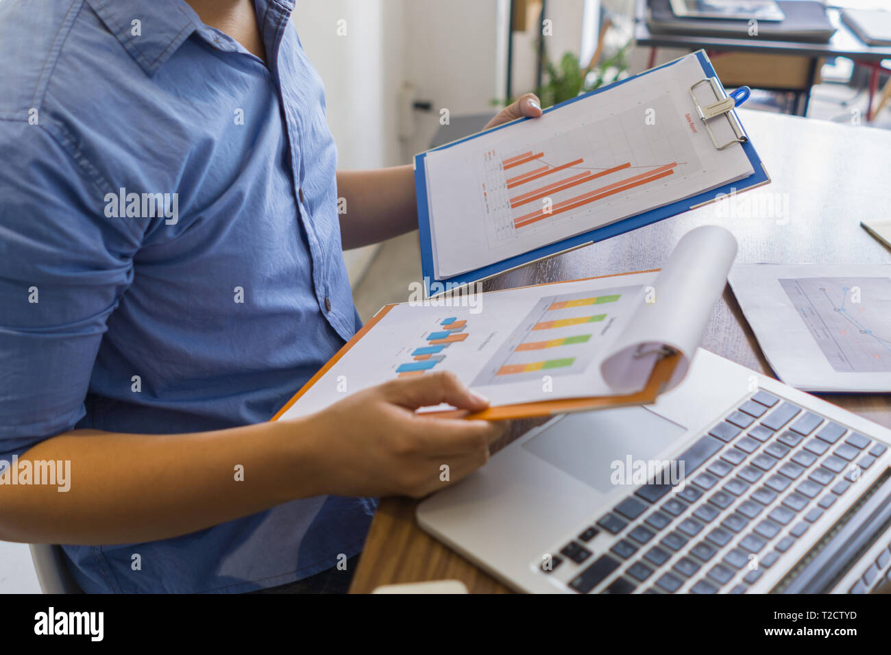 Male hand holding financial reports and reading Stock Photo - Alamy