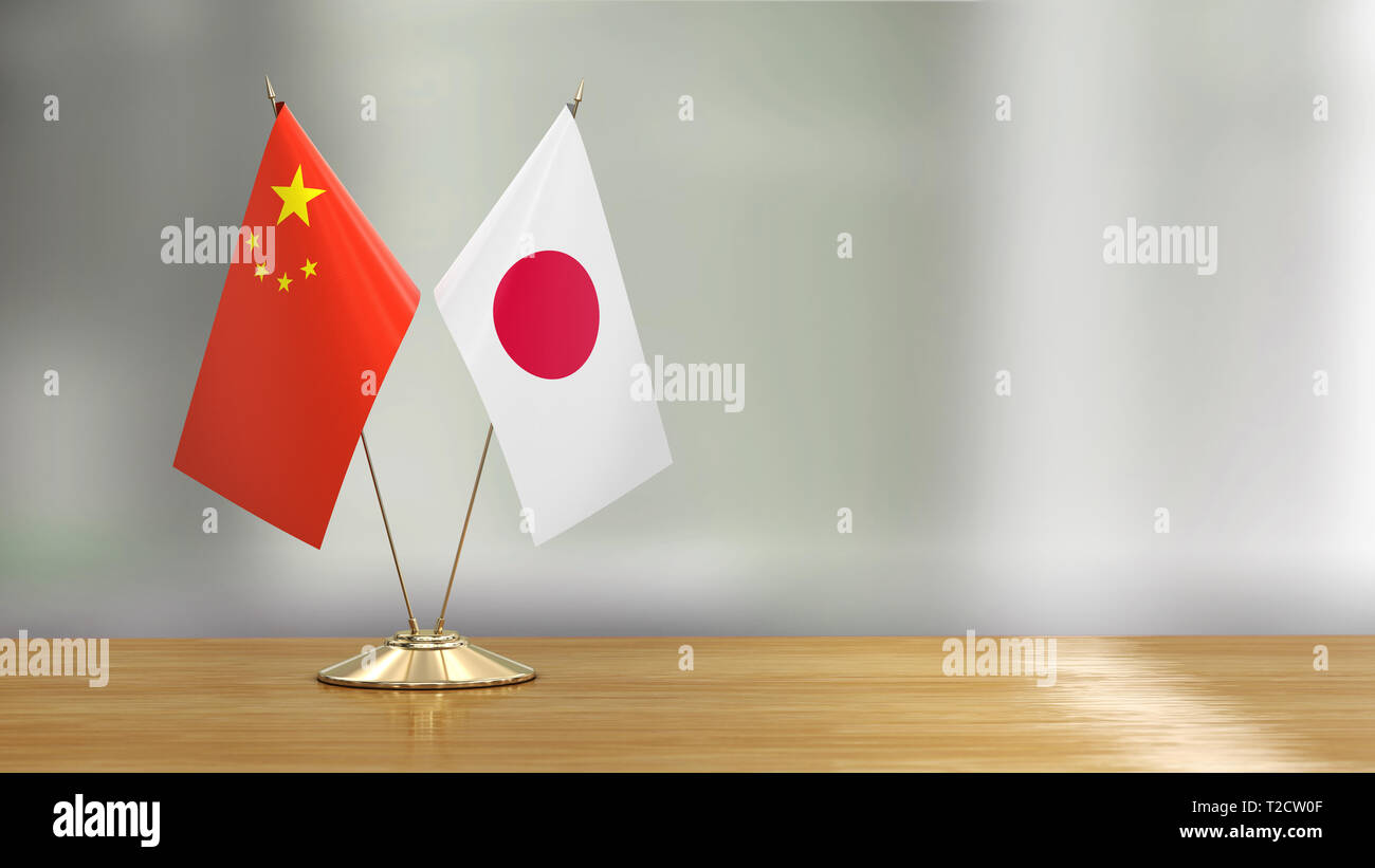 Flags pair on a desk over defocused background Stock Photo - Alamy