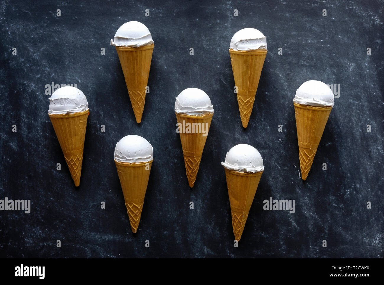 Neat symmetrical arrangement of seven ice cream cones with frozen ...