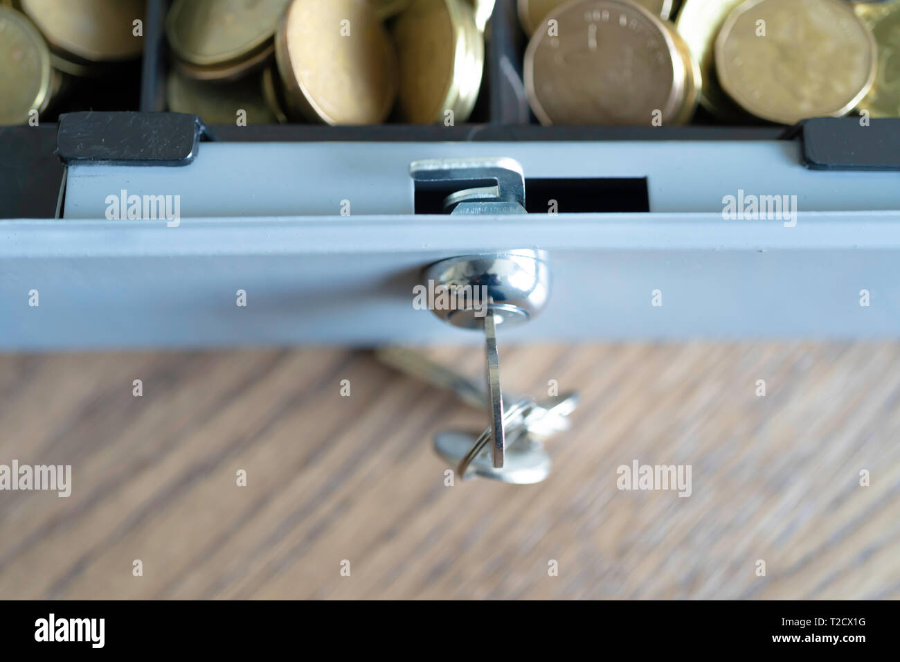 Cashbox lock with keys and full of Coins Stock Photo - Alamy