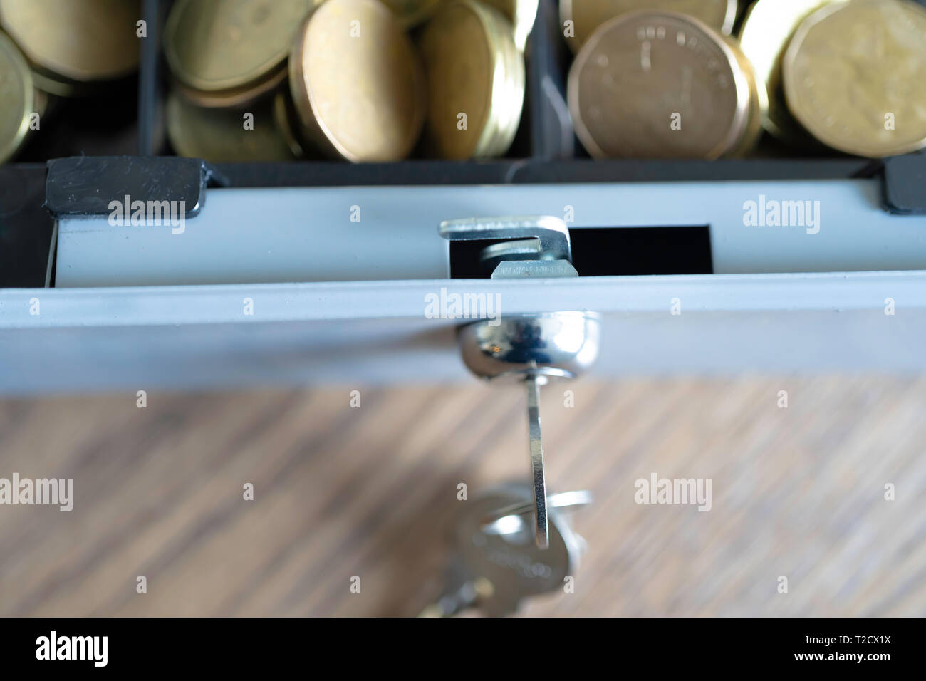 Cashbox lock with keys and full of Coins Stock Photo - Alamy