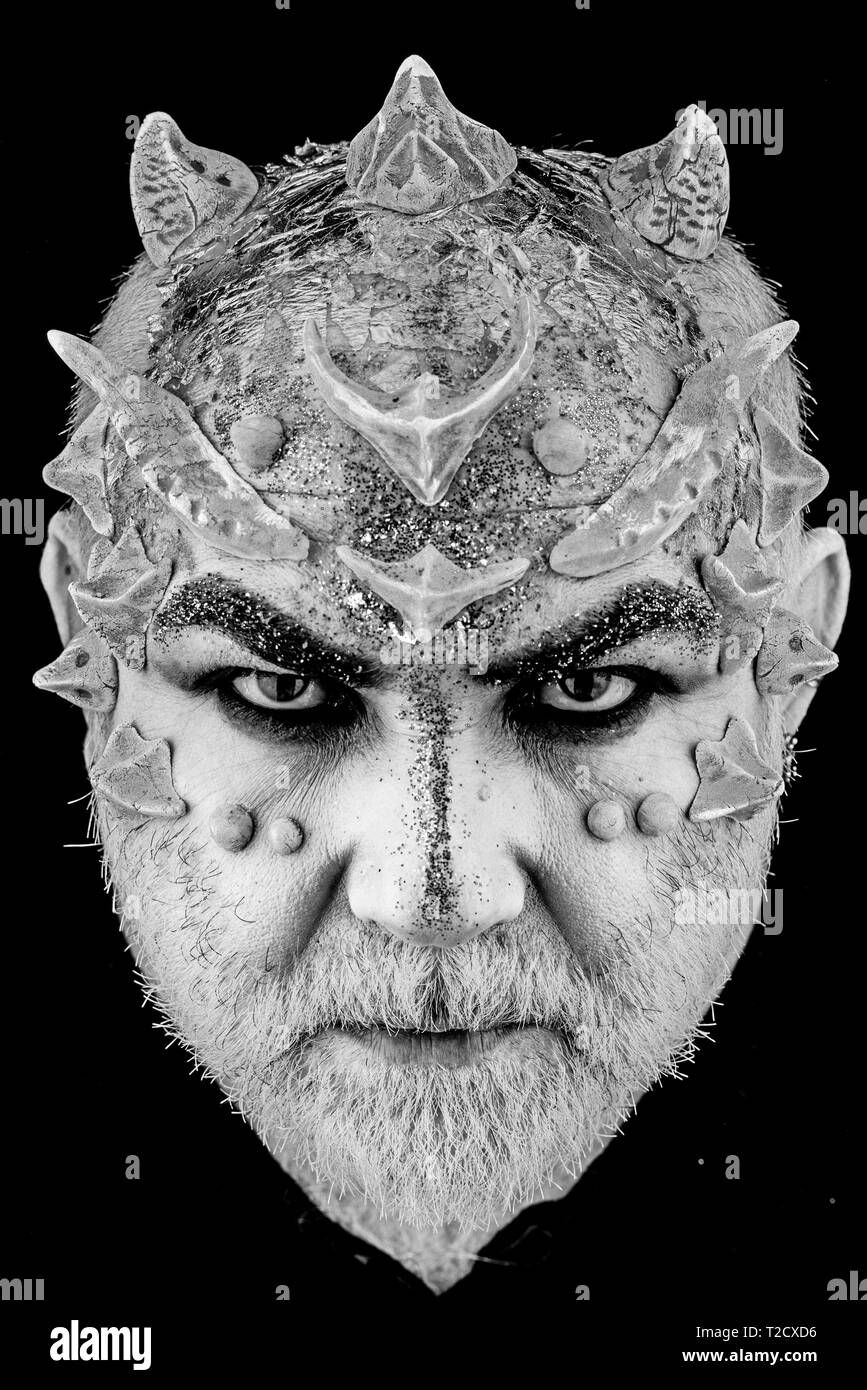 Head with thorns or warts, face covered with glitters, close up. Demon ...
