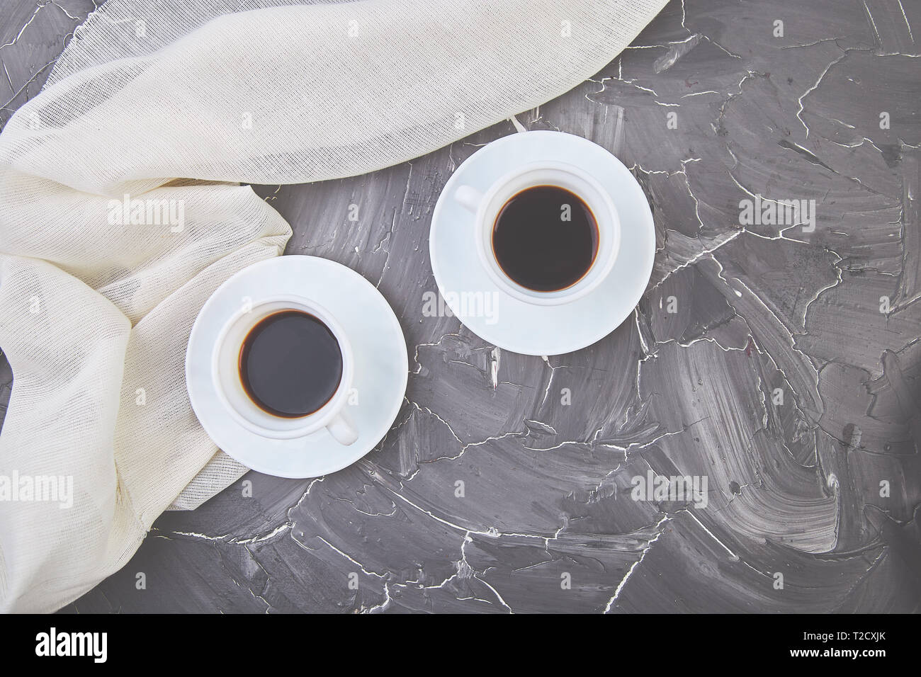 Two white cups of espresso on grey grunge background. Stylish toning ...