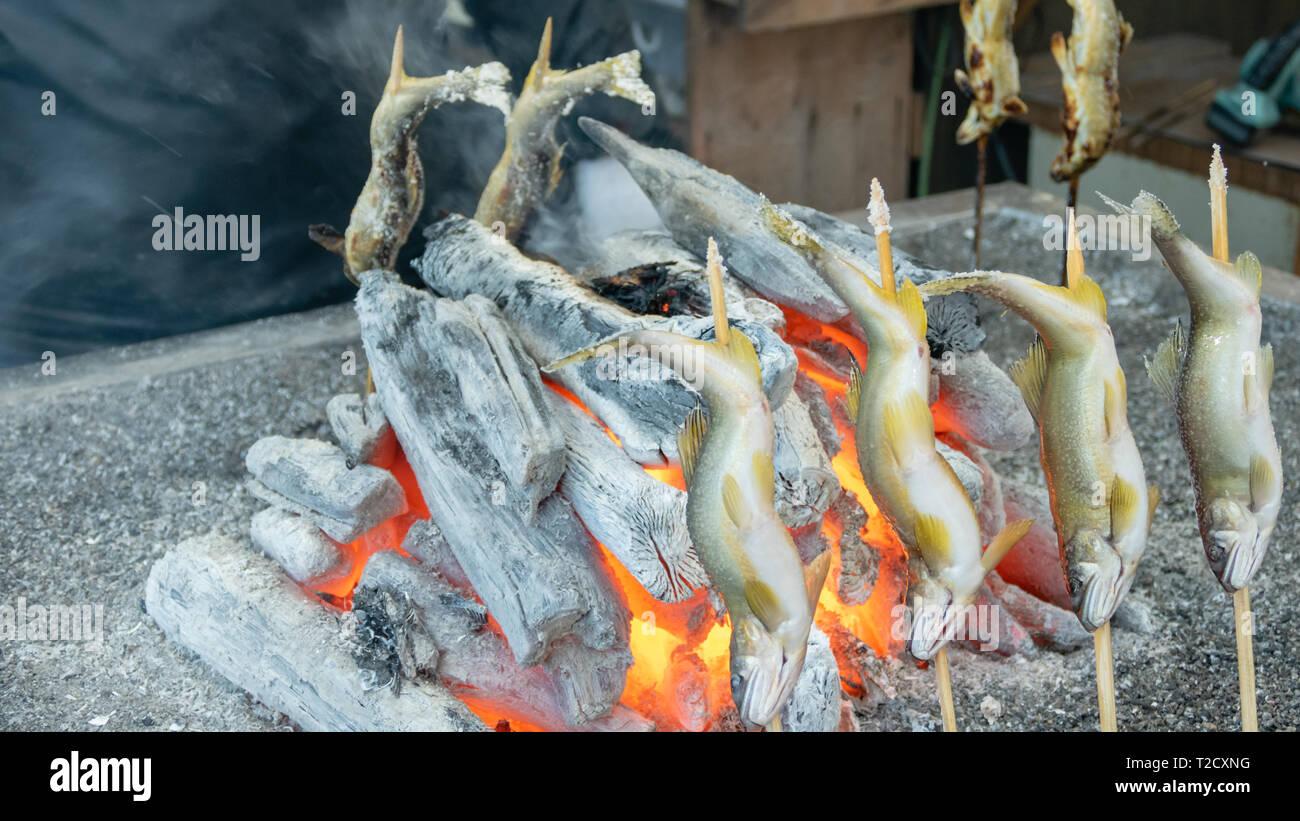 Grilled iwana or yamame fish, grilled next to coals on sticks, a famous ...