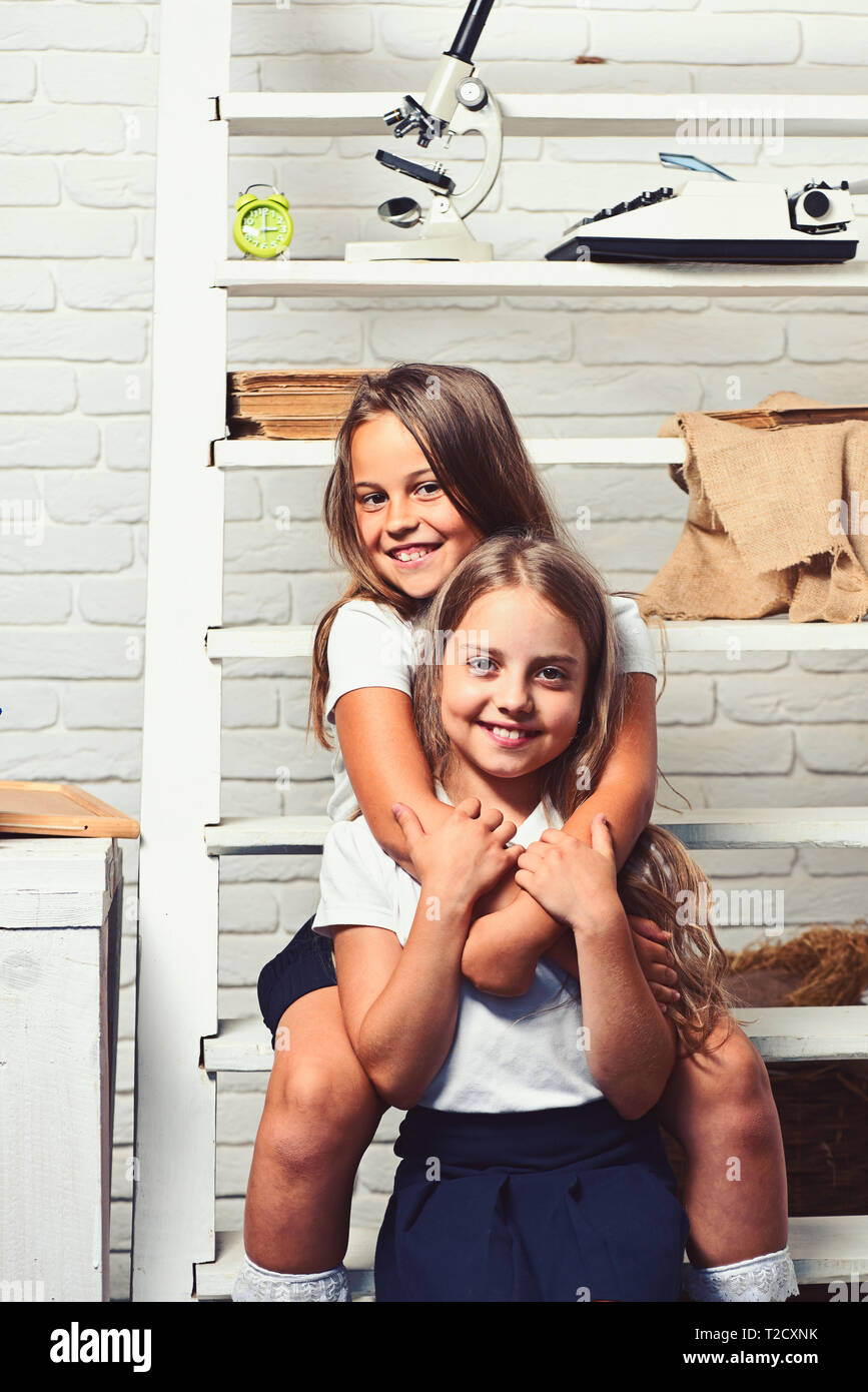 school. happy friends girls embrace in school classroom Stock Photo - Alamy