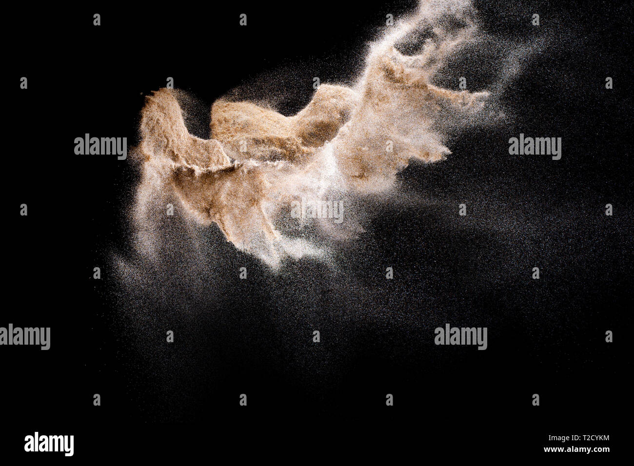 Brown dry river sand explosion isolated on black background. Abstract ...