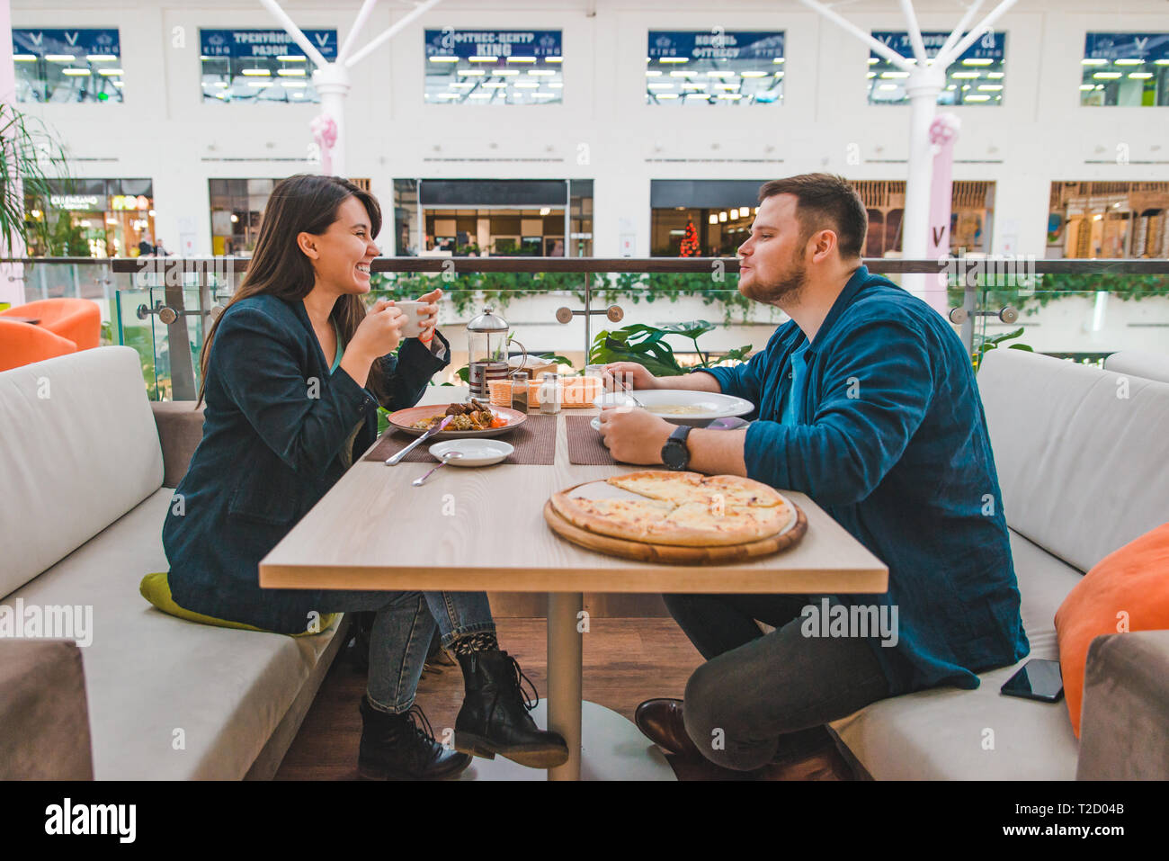 couple having lunch in mall cafe together. date talking. relationship ...