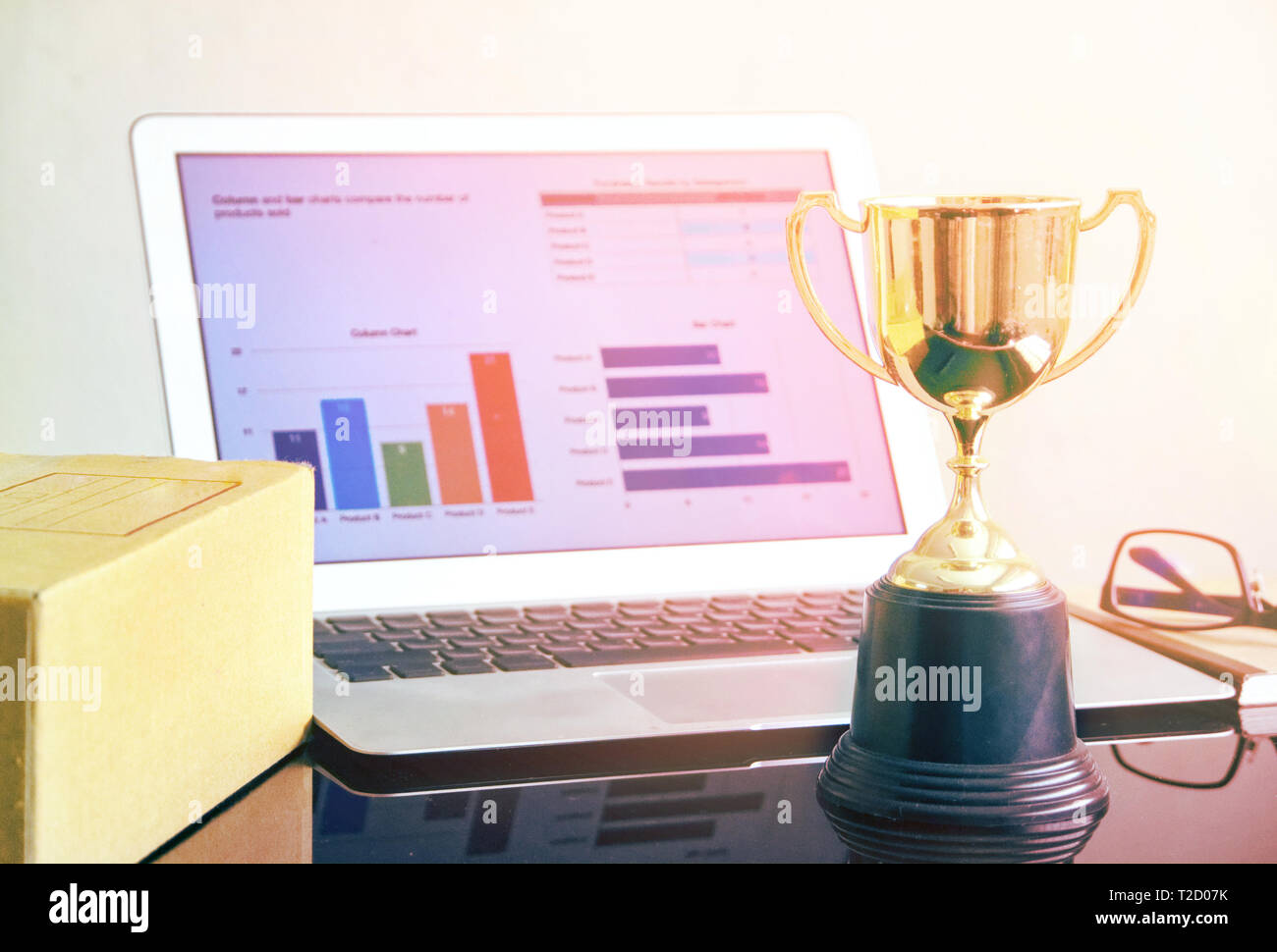 Winner trophy with computer notebook on working table,e-commerce ...