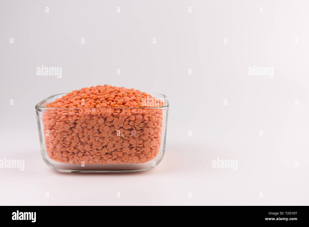 Red lentils in glass plate isolated on white background Stock Photo - Alamy