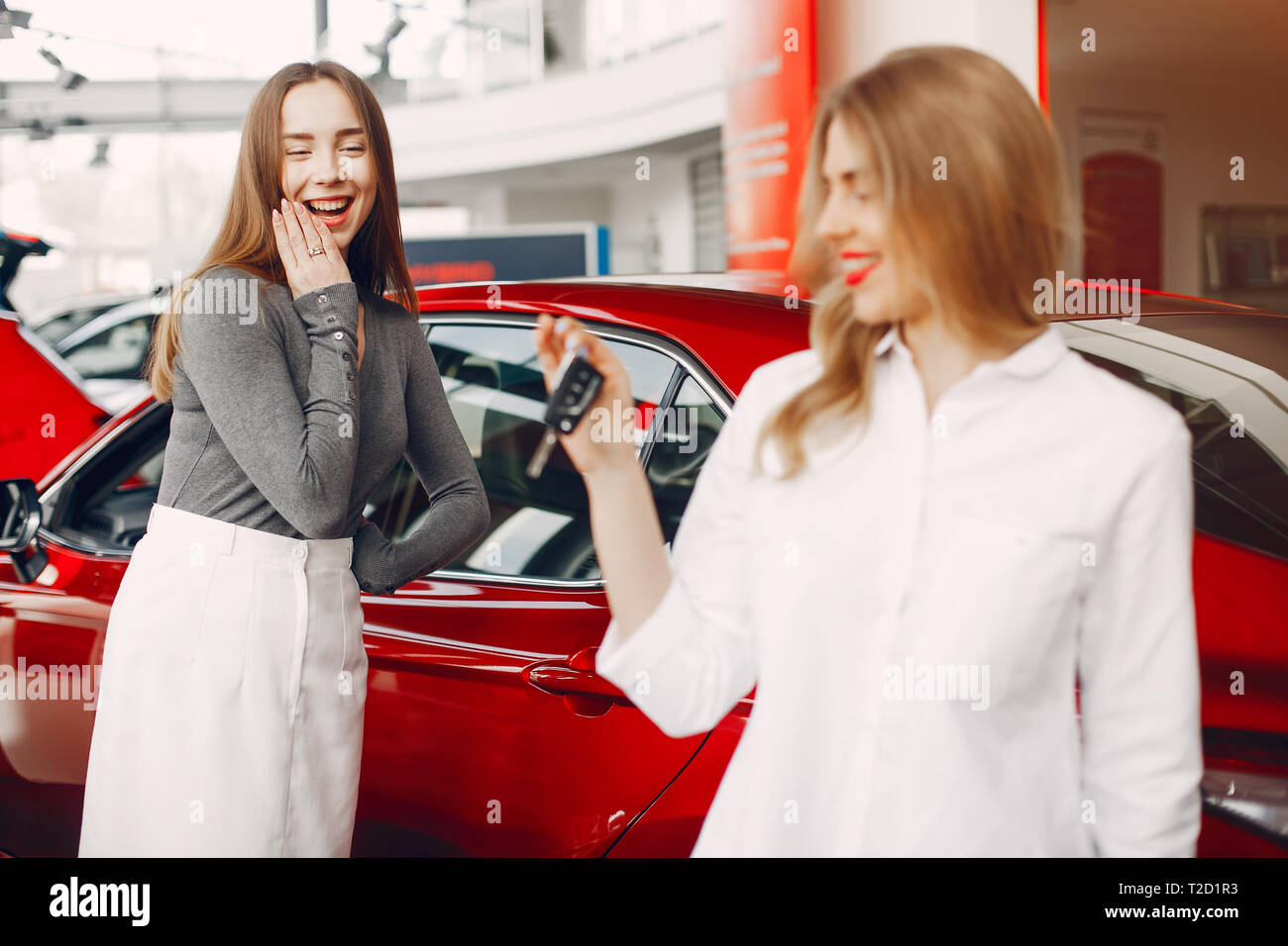 Women red car showroom hi-res stock photography and images - Alamy