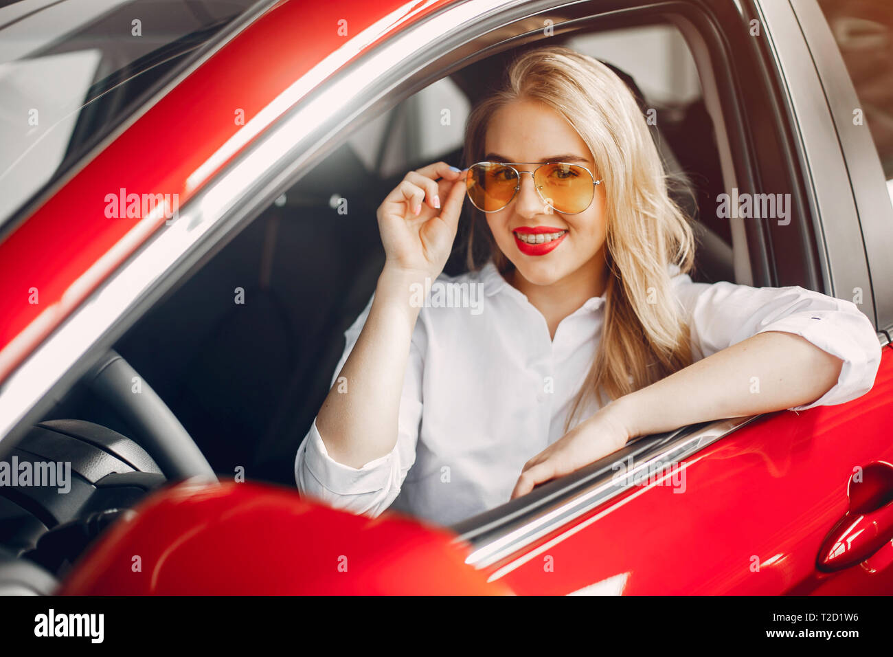 Woman buying the car. Lady in a car salon Stock Photo - Alamy