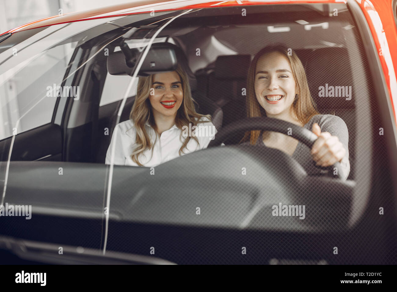 Women red car showroom hi-res stock photography and images - Alamy