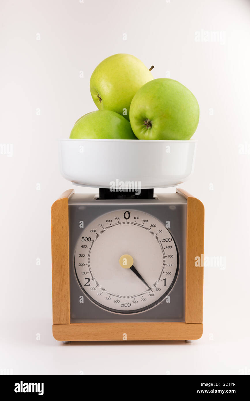 vintage wooden kitchen scales isolated on white background with green ...