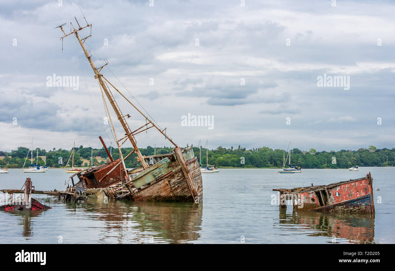 boat wrecks on the river orwell pin mill suffolk Stock Photo - Alamy