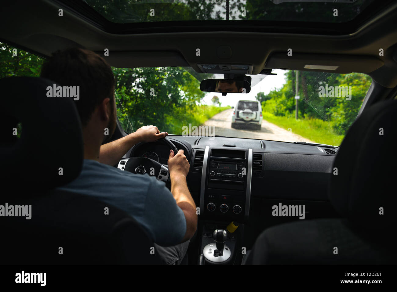 man driving suv car by forest trail road. adventure time Stock Photo ...