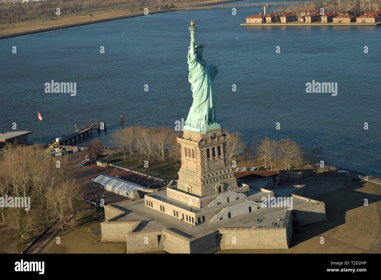 Aerial view of Liberty Island with Statue of Liberty at sunset time ...