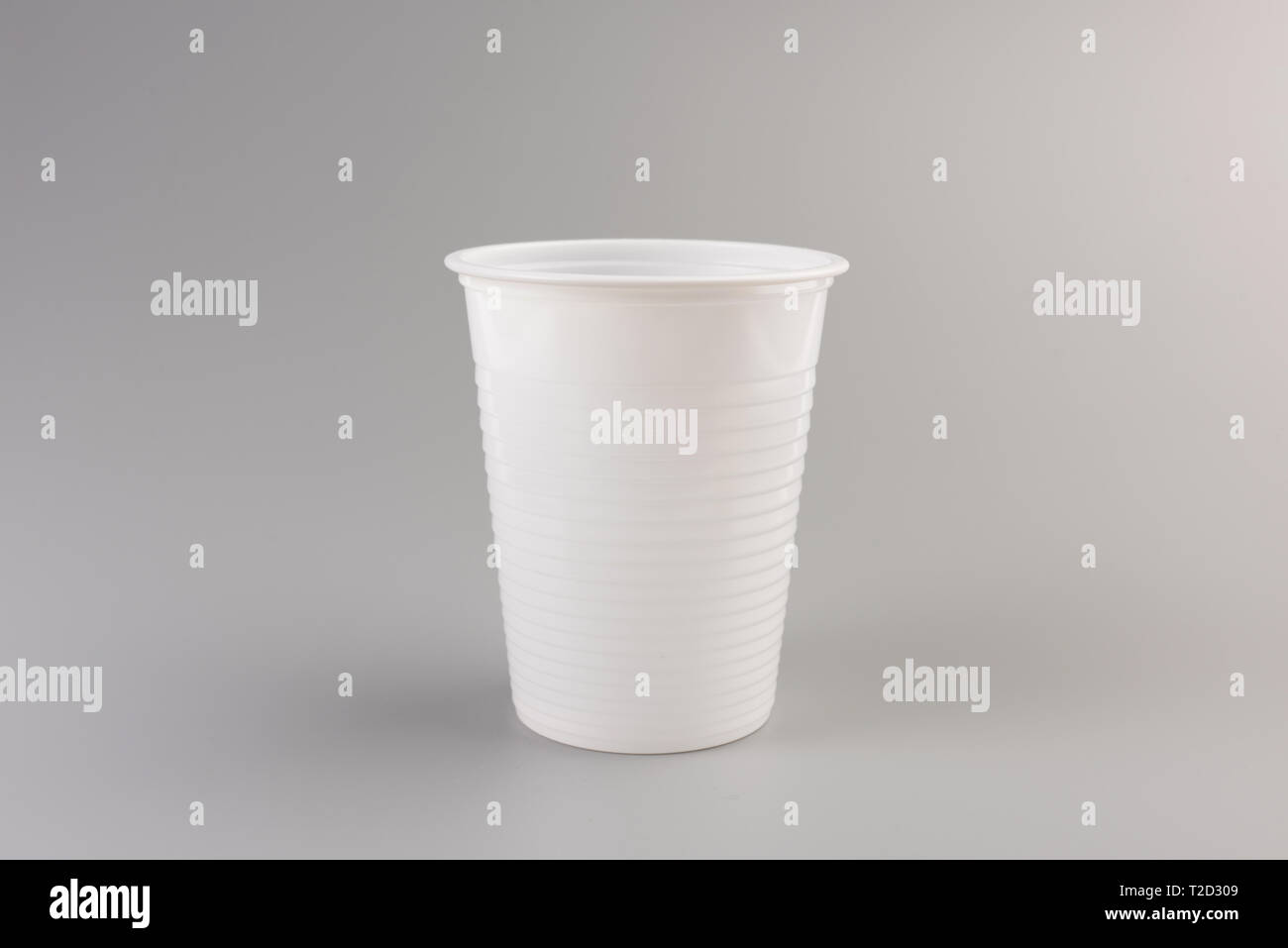 Round white Plastic Cup isolated on grey background Stock Photo - Alamy