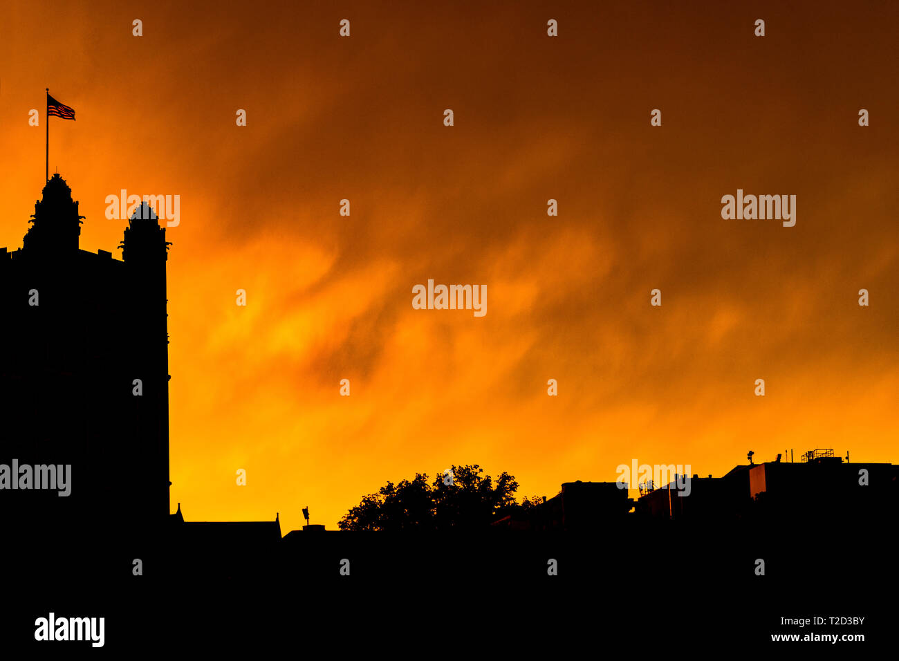 Silhouette of Harlem skyline with the American flag waving in the wind ...