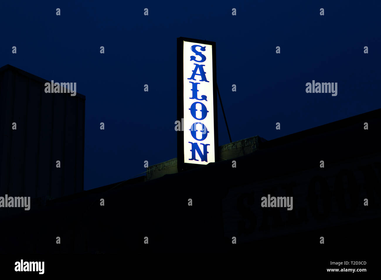 Saloon sign glowing through the night Stock Photo - Alamy