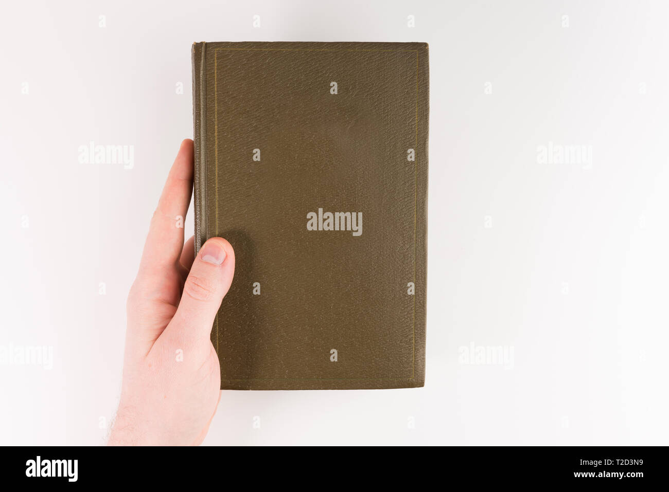 Overhead view of hands holding a blank closed book, isolated on white ...