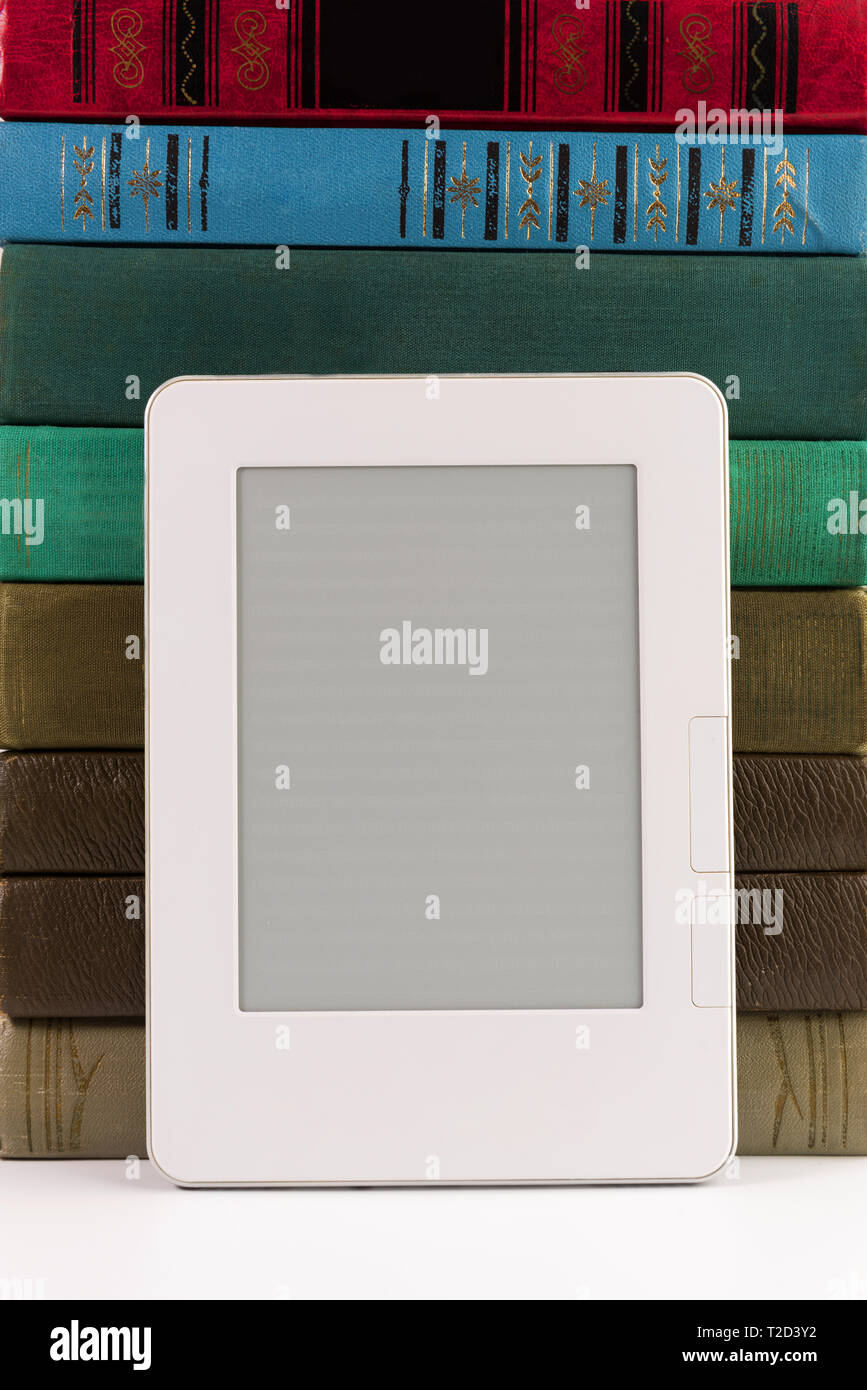 Electronic book with stack of regular old books Stock Photo - Alamy