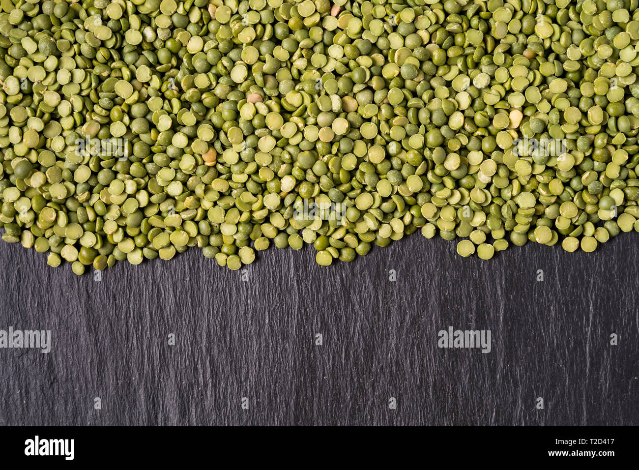 Flat lay with copy space of Small green lentils seeds of annual legume ...