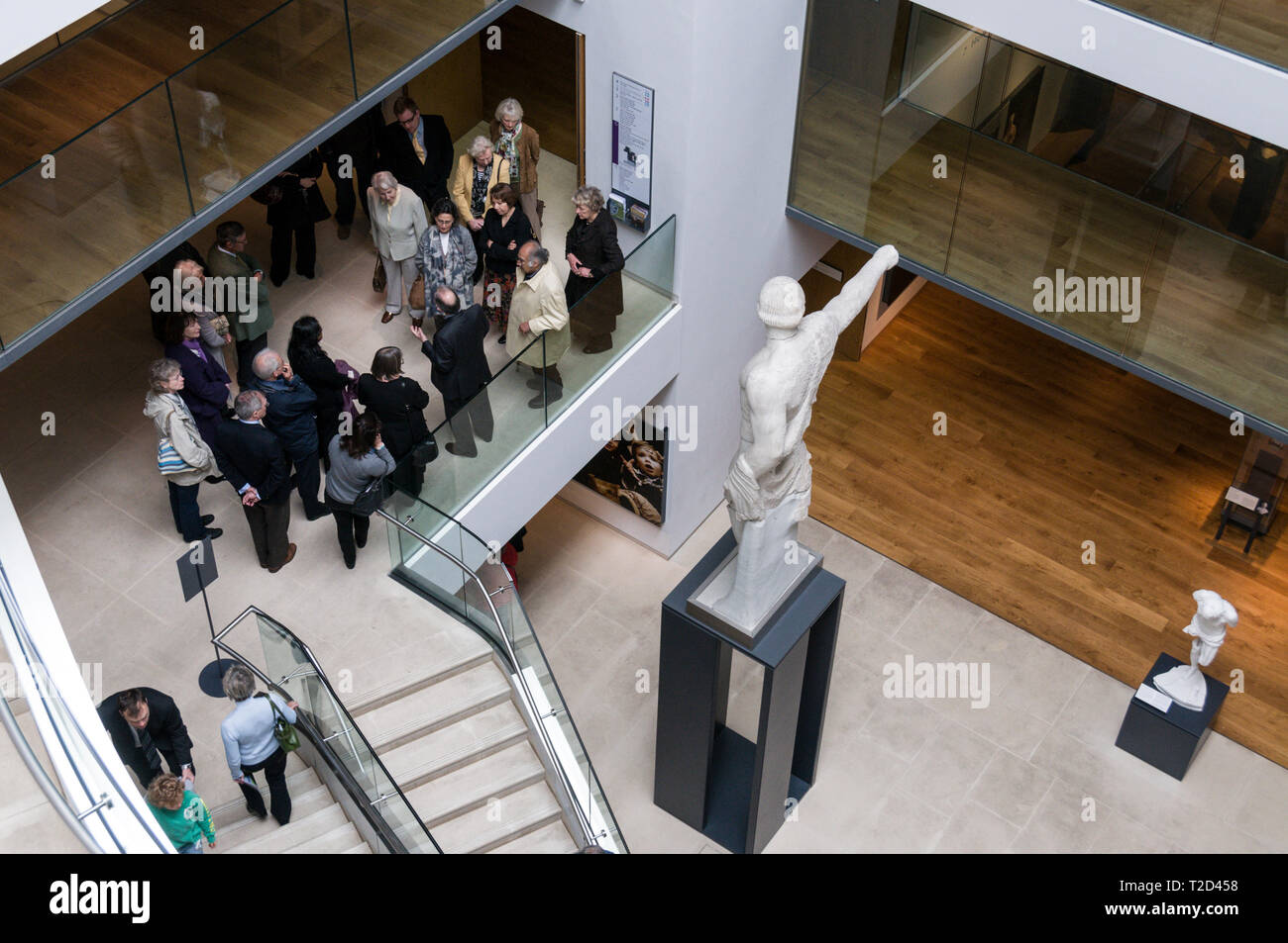 Visitors gather to listen to a tour guide on the first floor at the ...