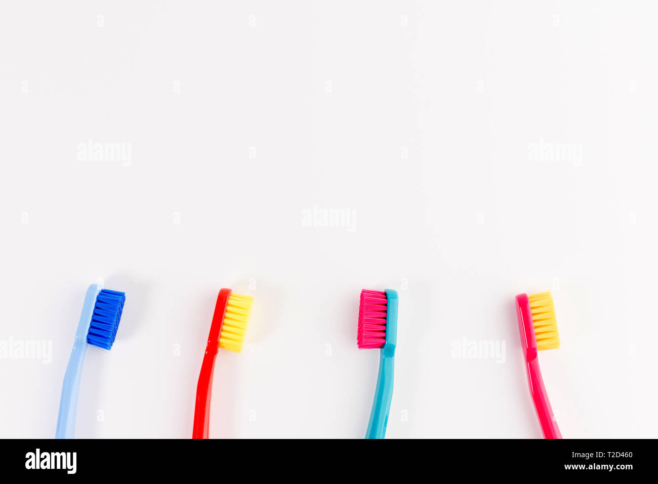 Red, pink, blue and light blue toothbrushes. Taking care of teeth ...