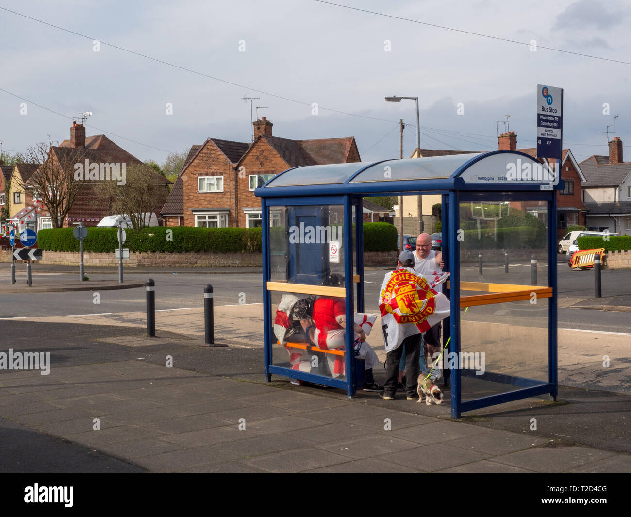 Football fans in a bus shelter Stock Photo - Alamy
