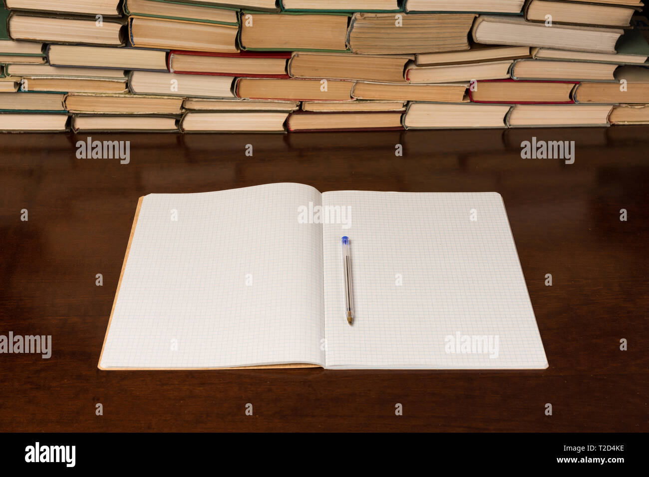 Blank open notepad with pen on the table with books background Stock ...