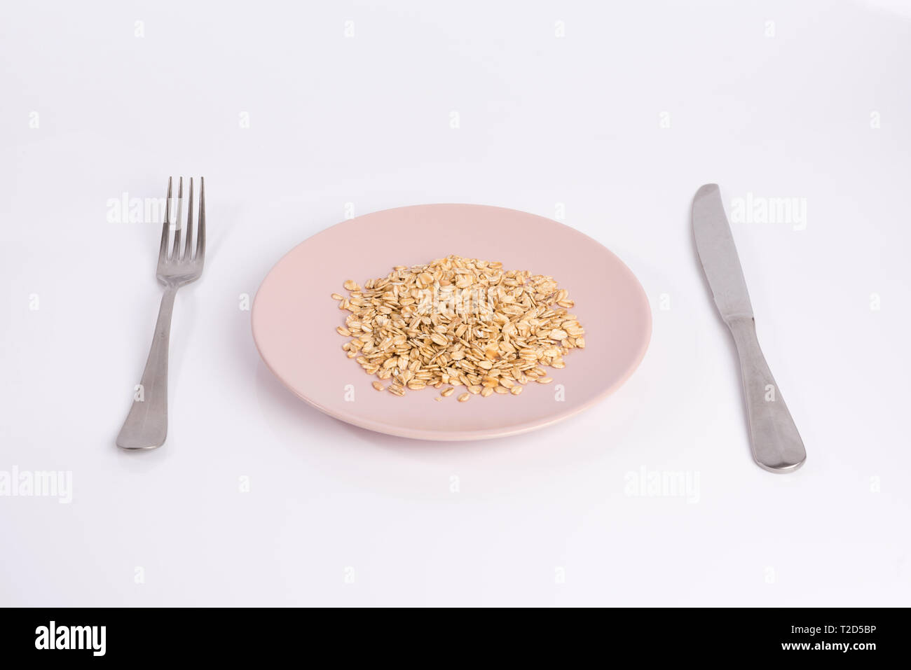 pile of oatmeal on a plate isolated on white background Stock Photo - Alamy