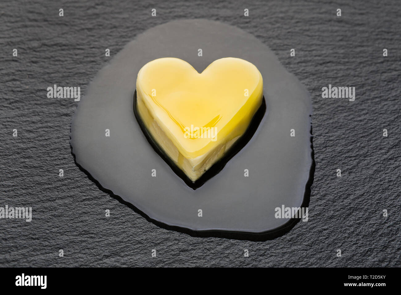 Heart-shaped piece of butter melting on black pan Stock Photo - Alamy