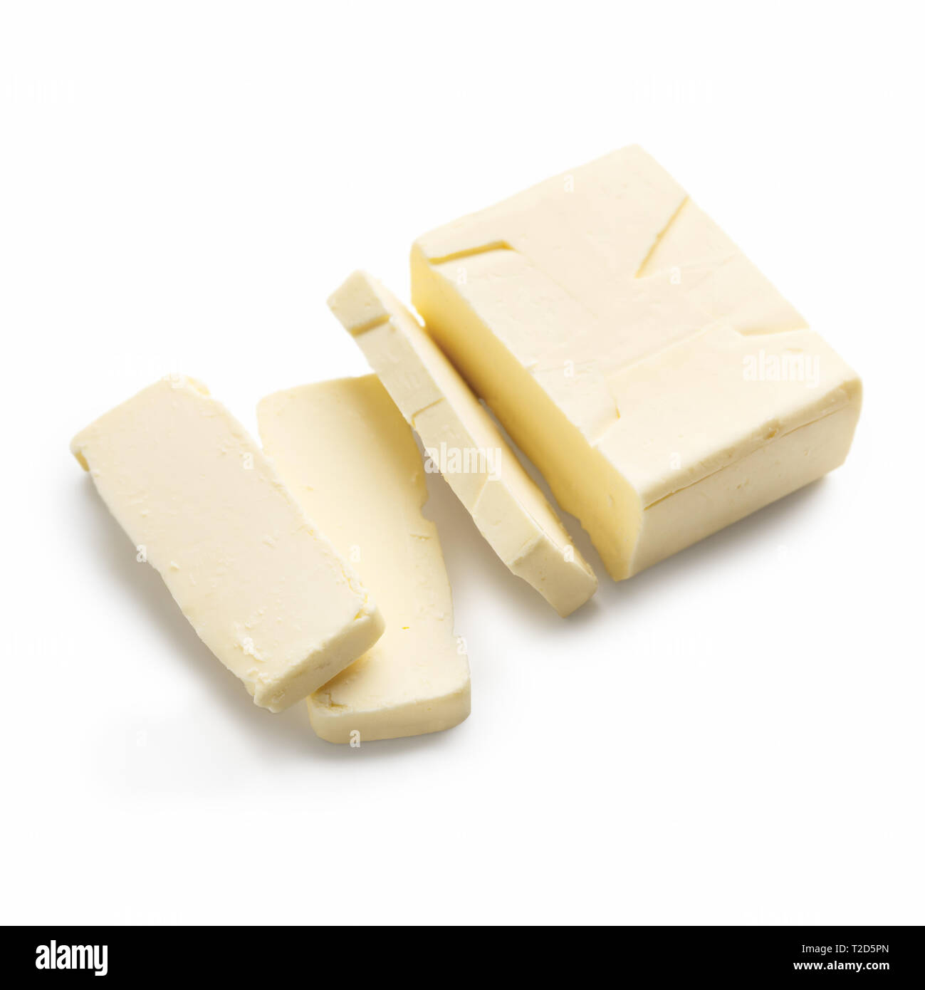 Block of butter sliced on white background. Dairy products concept ...