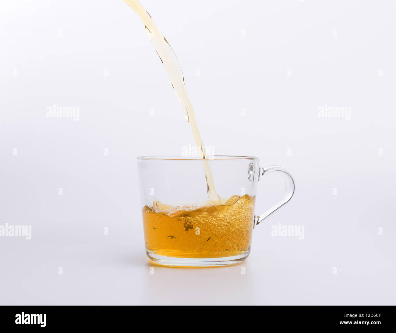 tea pouring in the cup isolated on white Stock Photo - Alamy