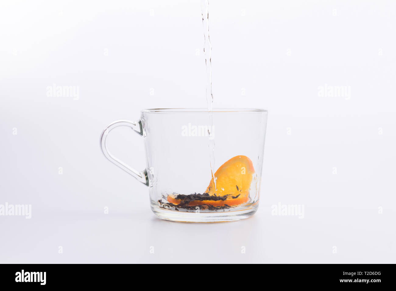 Tea pouring into glass cup isolated on white Stock Photo - Alamy