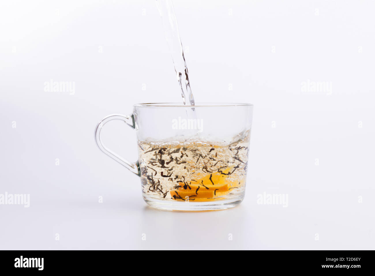 Black tea pouring into glass cup Isolated on white background Stock ...
