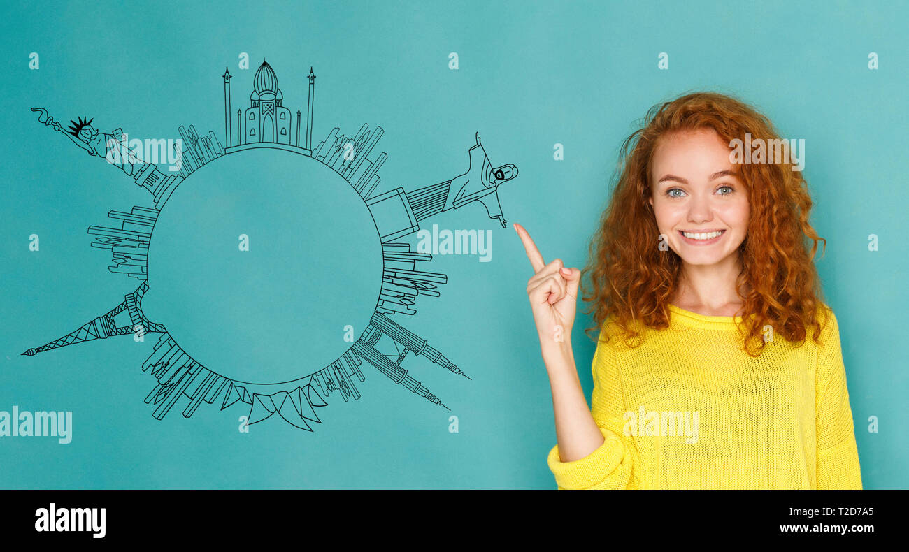 Young redhead woman pointing the finger at drawn circle from world ...