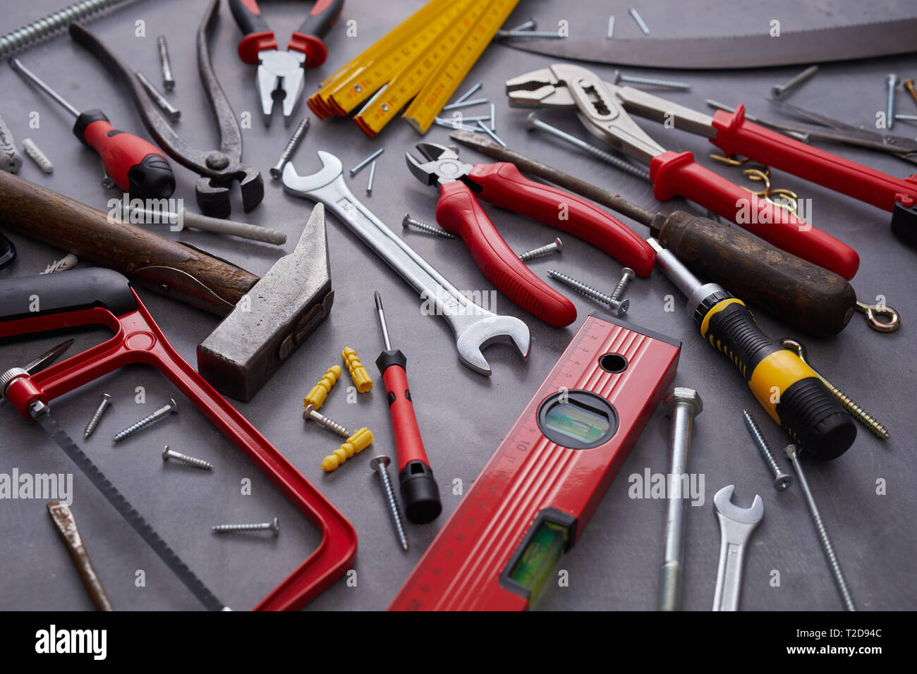 Assorted colorful red hand tools for building and construction mixed ...