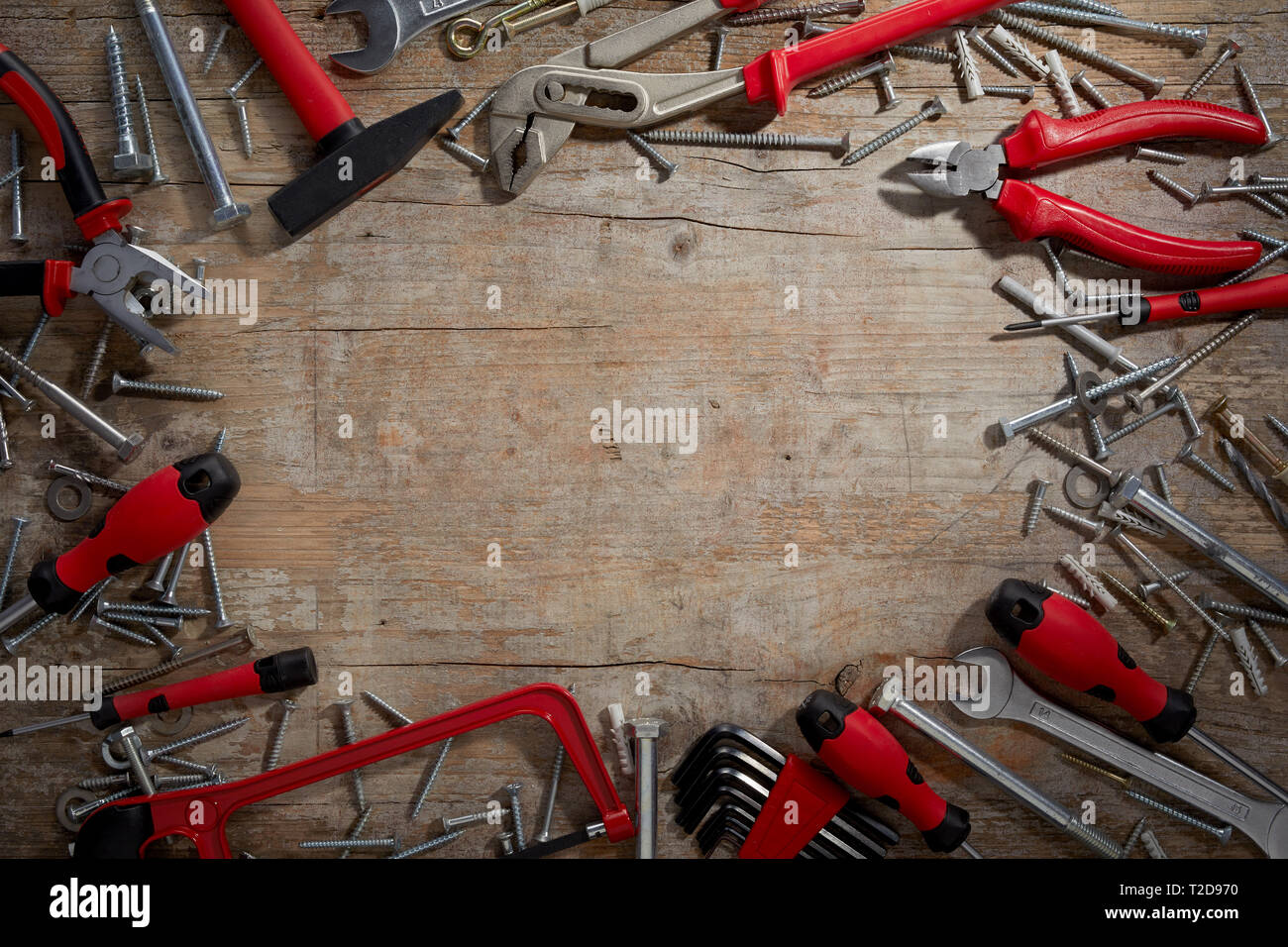 Colorful red hand tools in a DIY or renovations frame with scattered ...