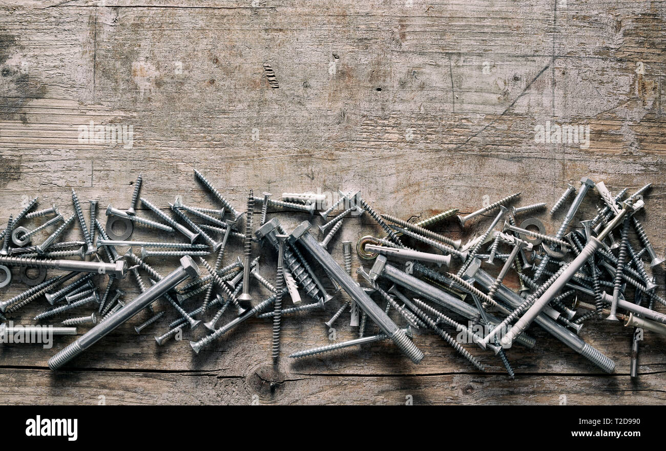 Assortment of different types of screw making a bottom border on old ...