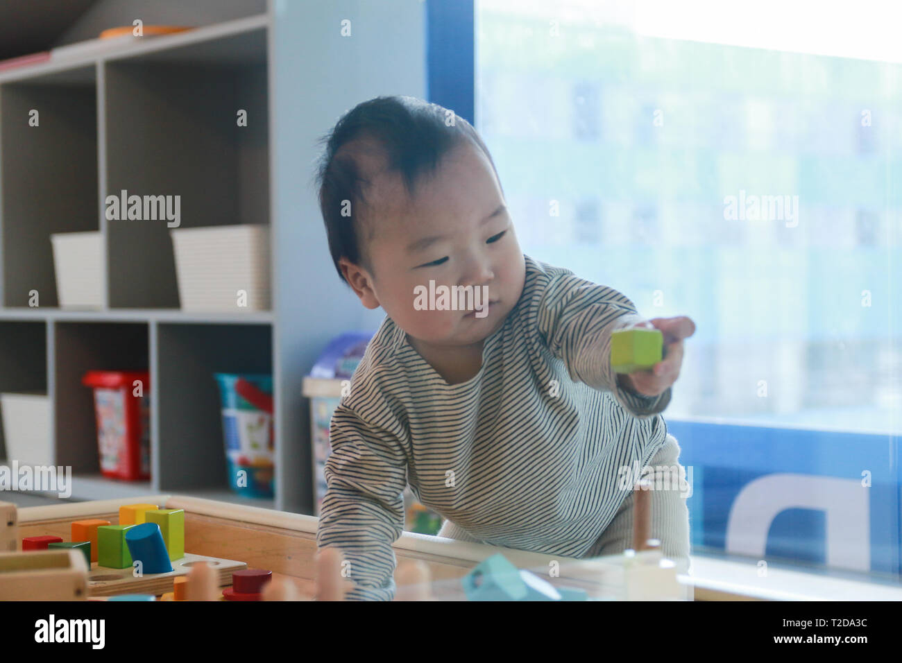 aisan baby playing with colorful wooden blocks Stock Photo - Alamy