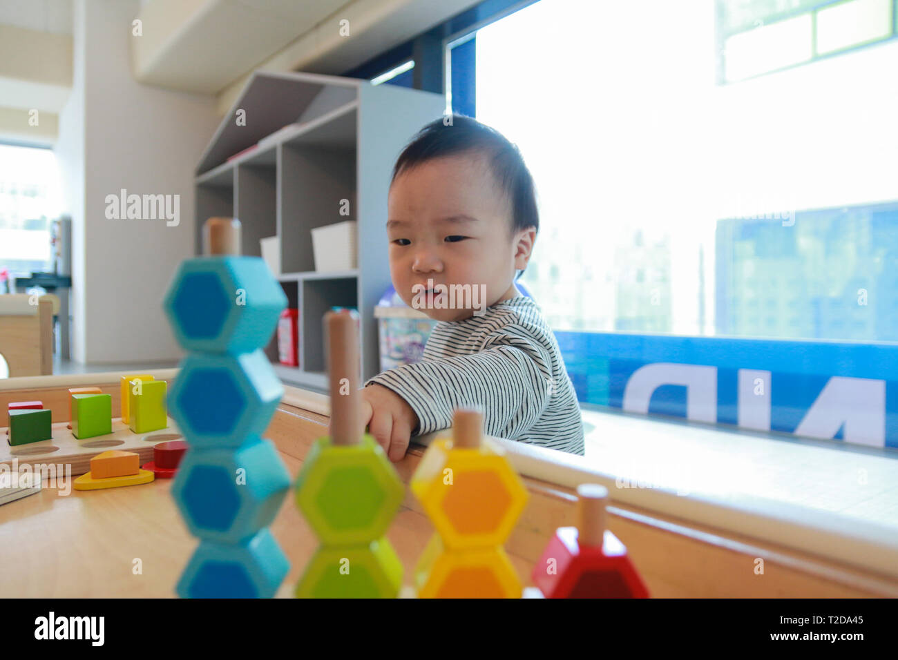 aisan baby playing with colorful wooden blocks Stock Photo - Alamy