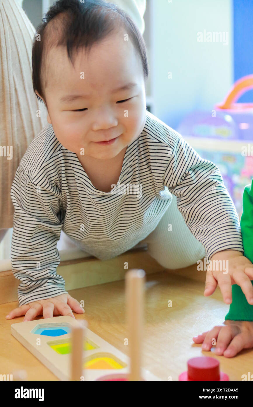 aisan baby playing with colorful wooden blocks Stock Photo - Alamy
