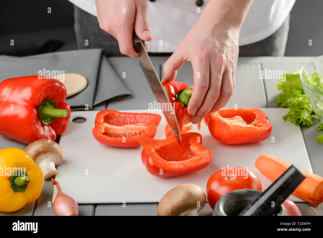 Bell pepper cutting tips. Quartered pepper on a board. Chef preparing ...