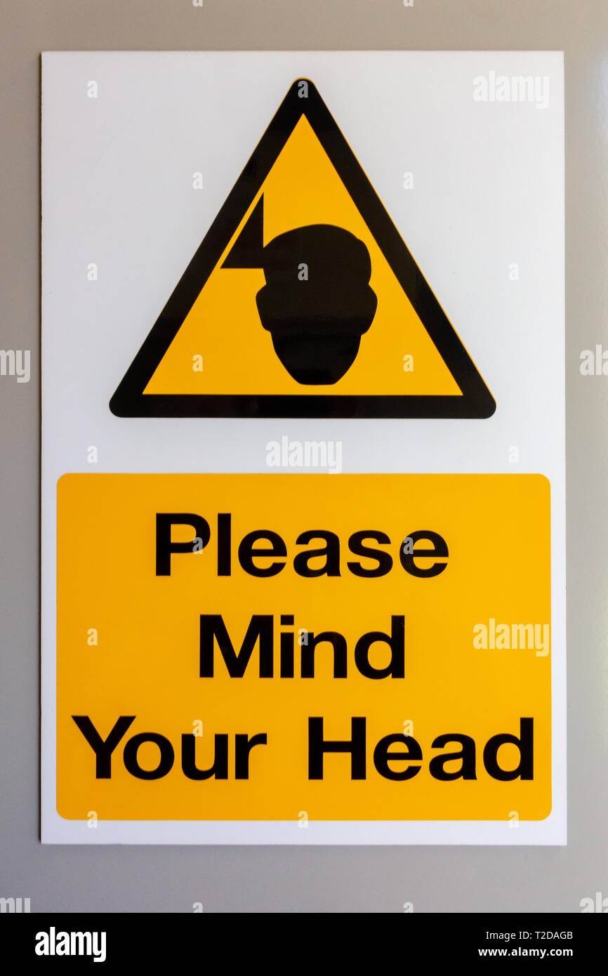Please mind your head warning sign Stock Photo - Alamy