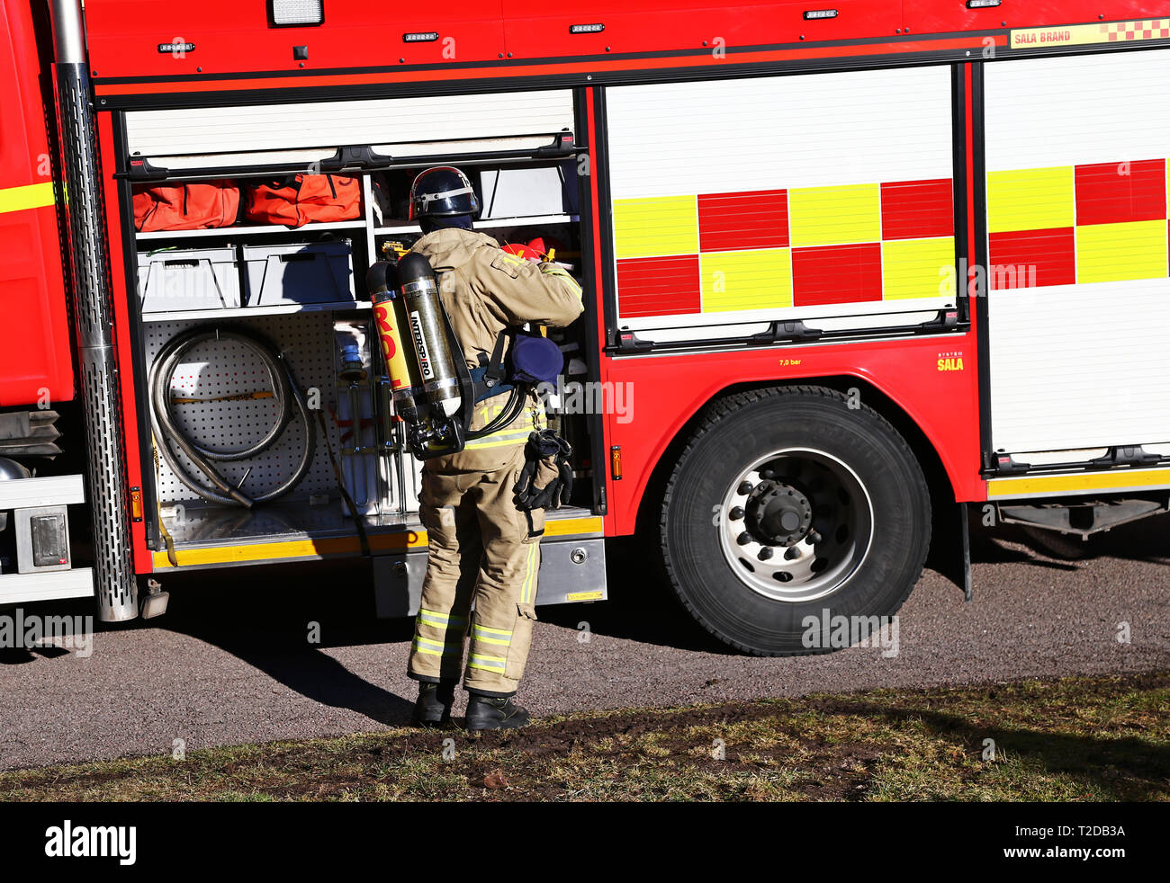 Firefighter at a fire truck Stock Photo - Alamy